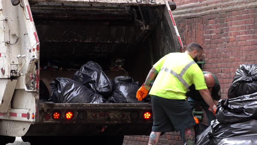 NEW YORK - AUGUST 20, 2015: DSNY Worker Tossing Garbage Into Truck ...