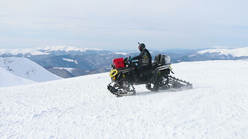 person-riding-snowmobile-with-mountains-in-the-background image - Free ...