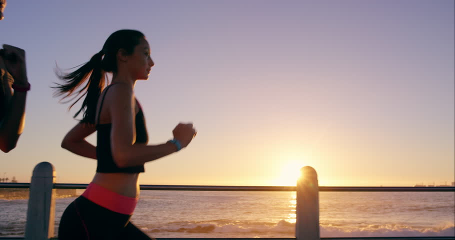 Two Athletic Woman Running Outdoors In Slow Motion On Promenade At ...