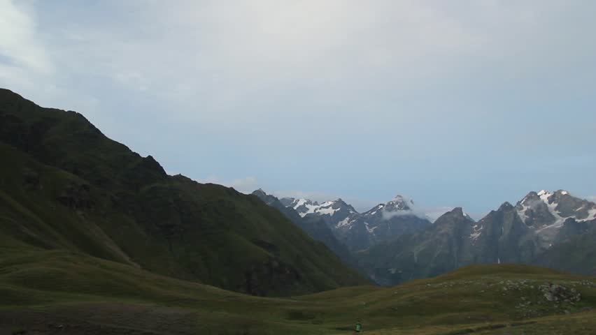 View Of The Snow-capped Mountains And Green Hills. From Down To Top ...
