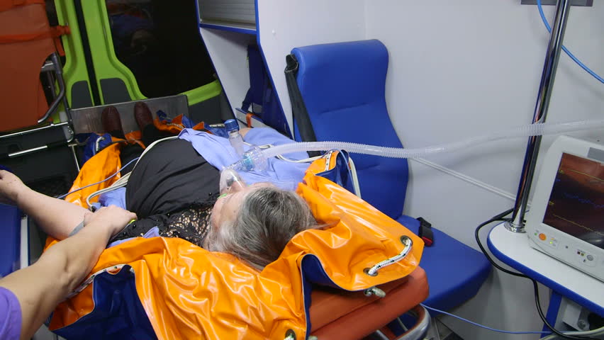 EMT Paramedic Provide Medical Care To Critical Senior Patient Wearing ...