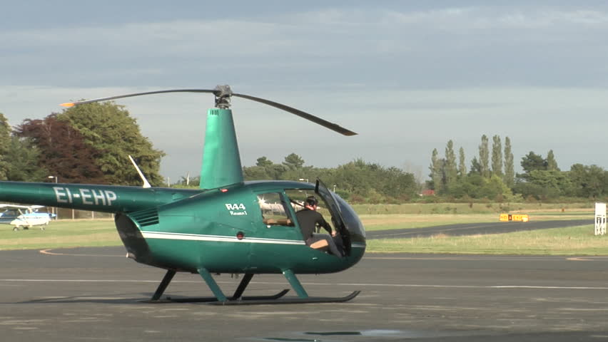 Helicopter Robinson R44 In Flight.Beautiful Clouds On The Background ...
