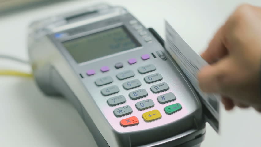 Stock Video Clip of Cashier swiping a credit card through machine ...