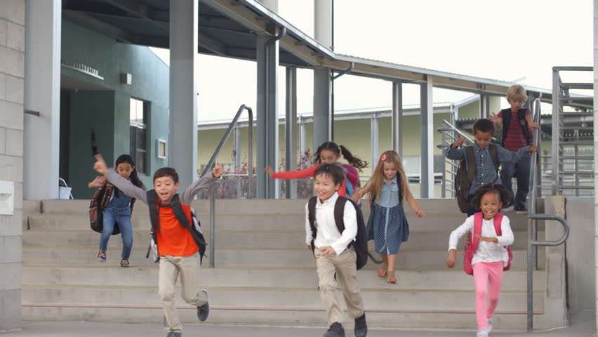 Young School Kids Jumping Down Steps As They Leave School Stock Footage ...