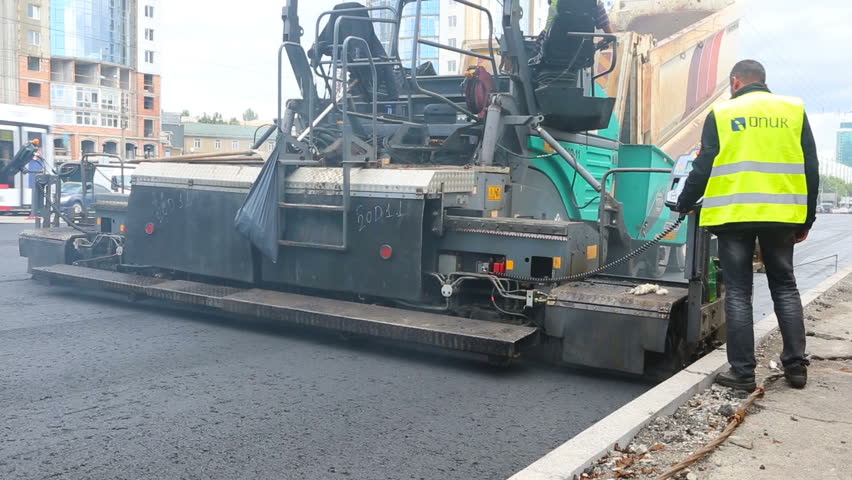 Asphalt Paver Applying Asphalt On The Highway. An Equipment Used To ...