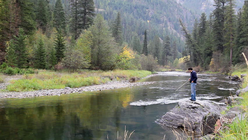 Stock video of young man fly fishing on a | 1975357 | Shutterstock