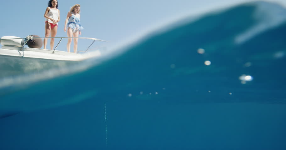 Women Jumping Off Boat Into Ocean Two Girls Jump Into Clear Blue Water ...