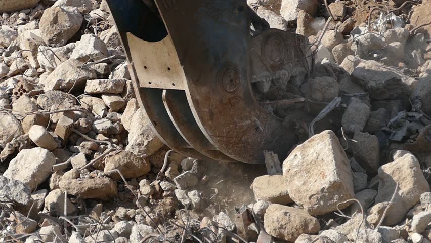 Close-up Of Heavy Demolition Machinery At Work, Crumbling And Moving ...