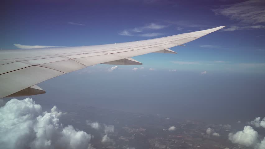 Passenger Plane In Flight. Airplane's Wing Flying Above Blue Sky ...