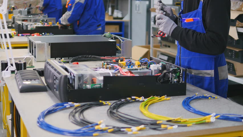 Factory Worker Assembling Electric Equipment - Transformer - On ...
