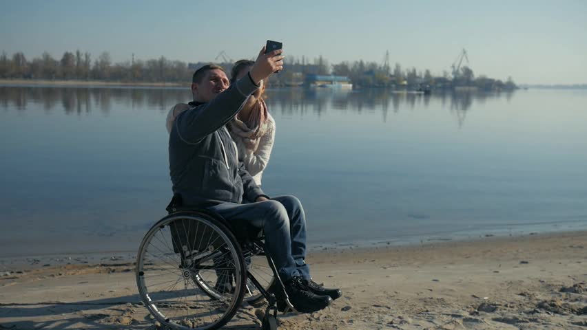 Male Cripple Speaking On Mobile Phone, Physically Disabled Man Sits In ...