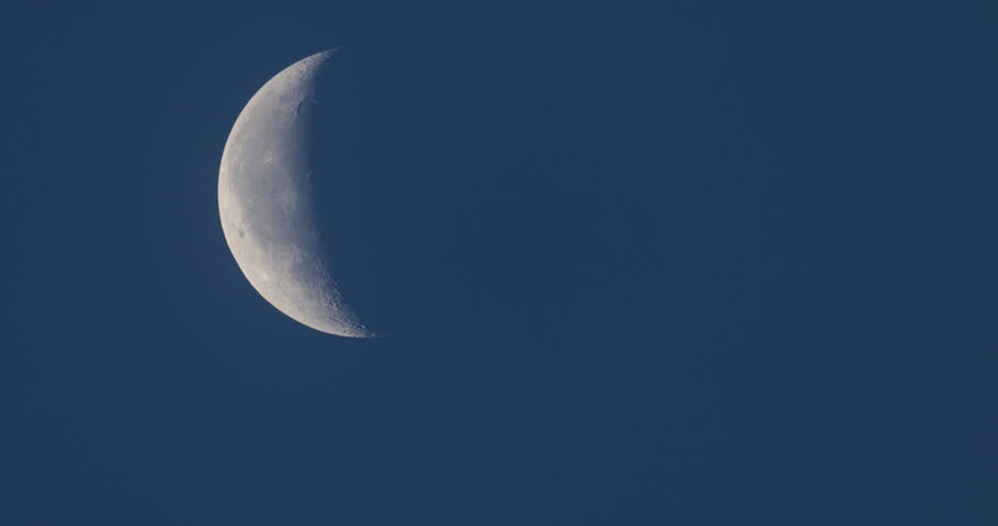 The Waning Crescent Moon Moves Slowly Across The Blue Sky During ...