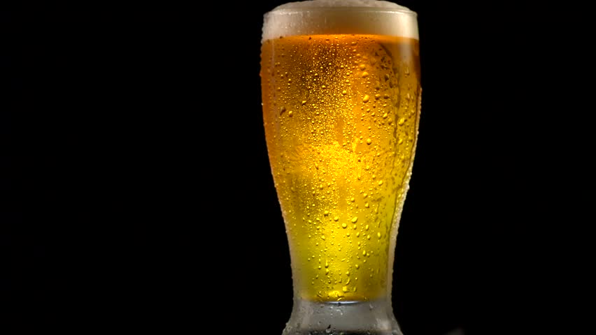 Cold Light Beer In A Glass With Water Drops Over Matte Black Background ...
