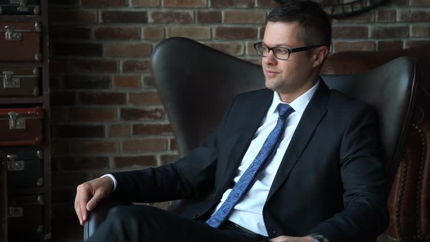 Young, Handsome Men Sitting Behind The Desk And Rewriting Something ...