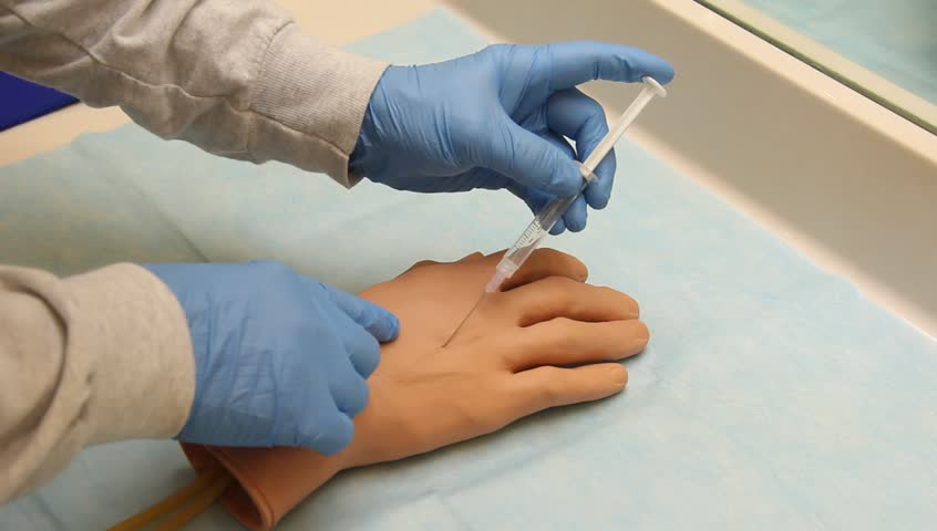 Stock Video Clip of needle injection practice on an artificial hand ...