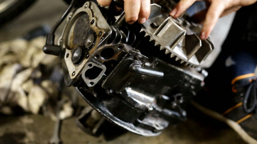Stock Video Clip of Young man cleaning a dirty engine of | Shutterstock