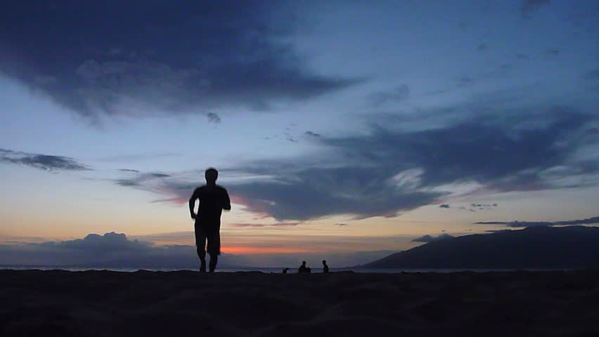 Man Running Away From Camera Towards The Ocean During Evening Sunset At ...