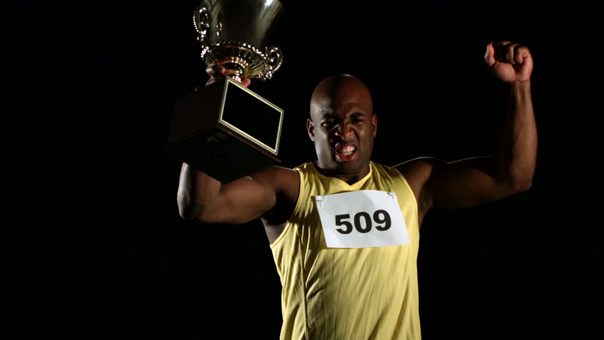 Stock video of track athlete celebrating with trophy, slow | 4558217 ...