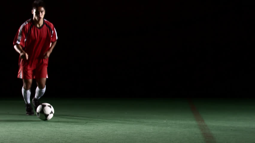 A Soccer Player Runs Up To The Camera And Then Kicks The Ball Out Of ...