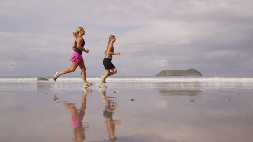 Women Running On Beach, Slow Motion. Shot On RED EPIC For High Quality ...