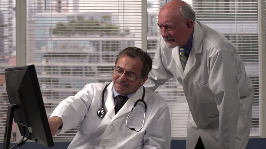 Stock video of two doctors looking at a computer | 5146517 | Shutterstock