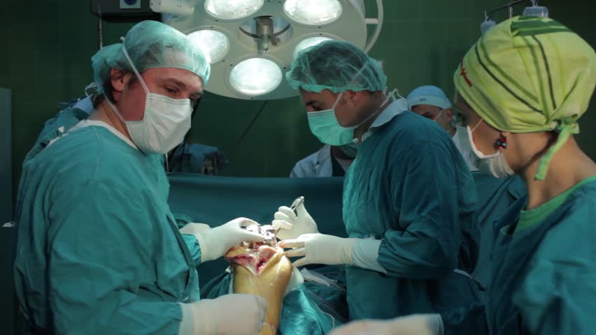 Surgeons Team Preforming Operation In Hospital Operating Theater ...
