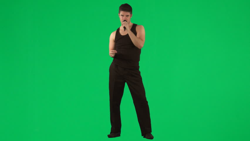 A Musician Singing With A Chrome Mic, On A Green Screen Background ...