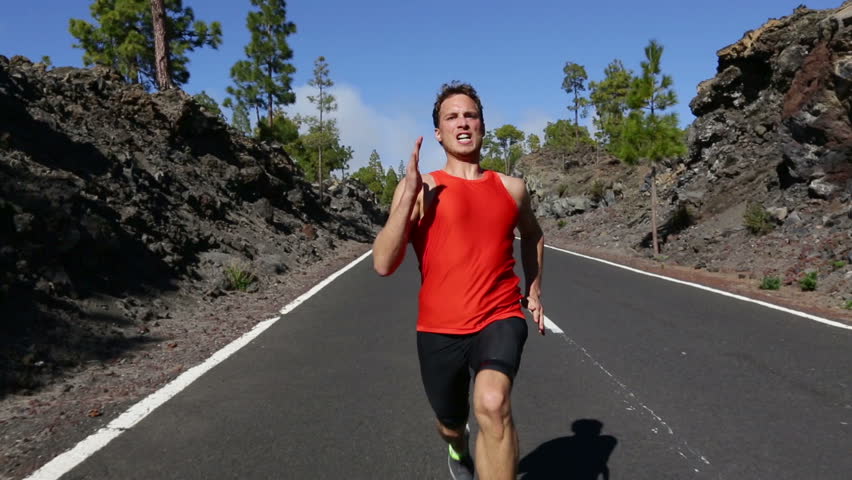 Running Man. Male Runner Training With Determination Outdoors On Road ...