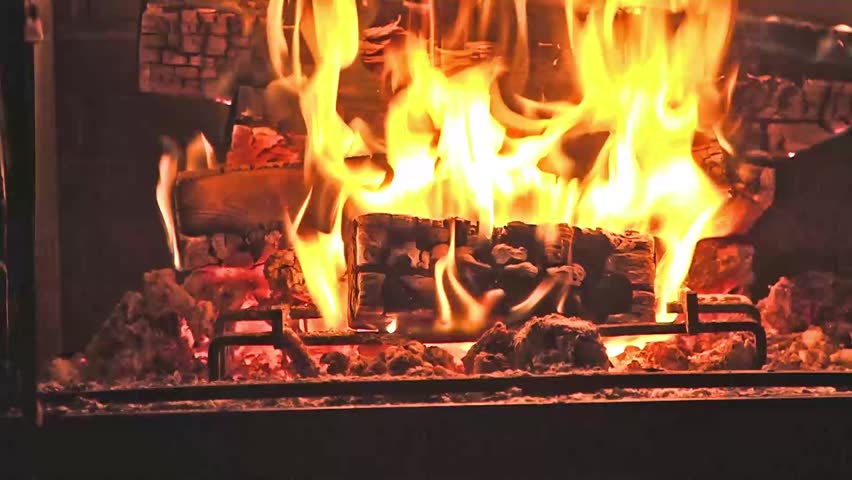 Man Stoking Fire With Stick - Wood Burning Fire With Flames In ...