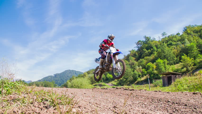 Low Angle Shot Of Motocross Rider Landing After Jump In Slow Motion ...