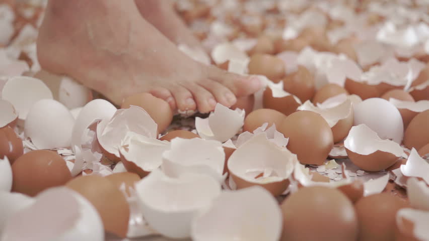 Feet Standing On A Floor Covered In Broken Egg Shells. Stock Footage ...