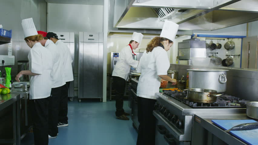 Team Of Chefs In A Professional Kitchen Doing Dishes And Cleaning The ...