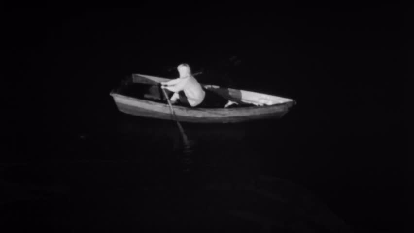 Stock Video Clip of Woman rowing a boat at night | Shutterstock