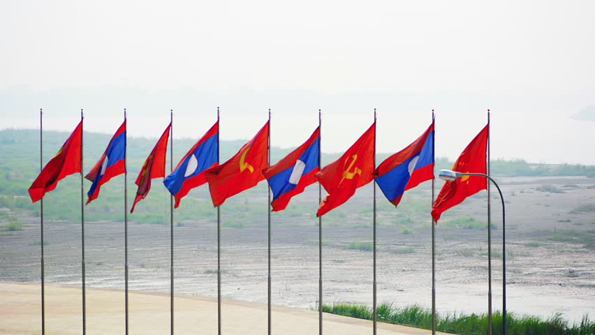 Laos And Communist Flag Waving Against Blue Sky In Vientiane Laos Stock ...