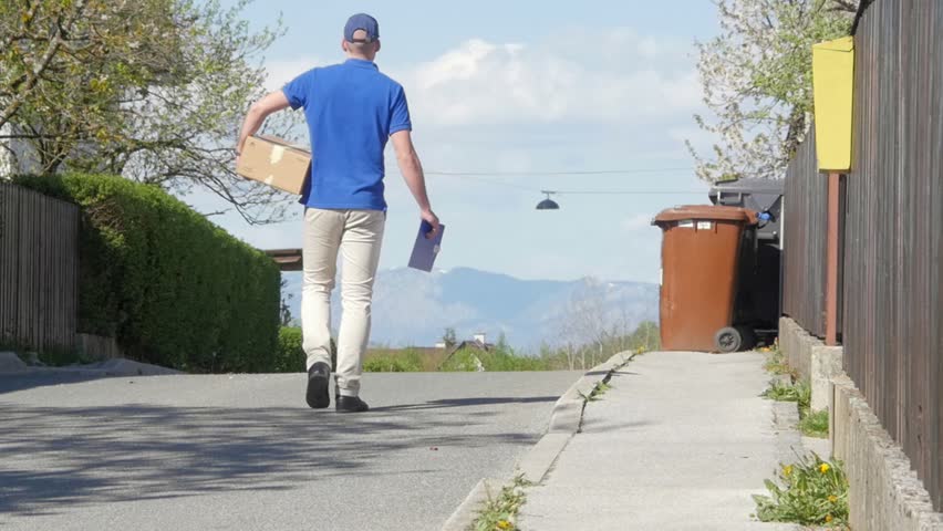 Stock Video Clip of Slow motion of a delivery guy with | Shutterstock
